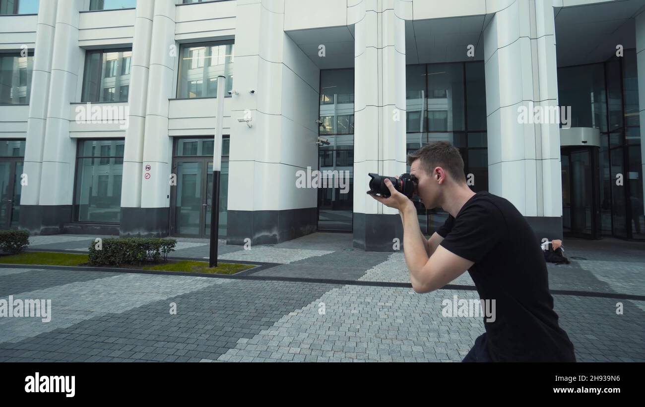 Photographer takes pictures of city's modern architecture. Action ...