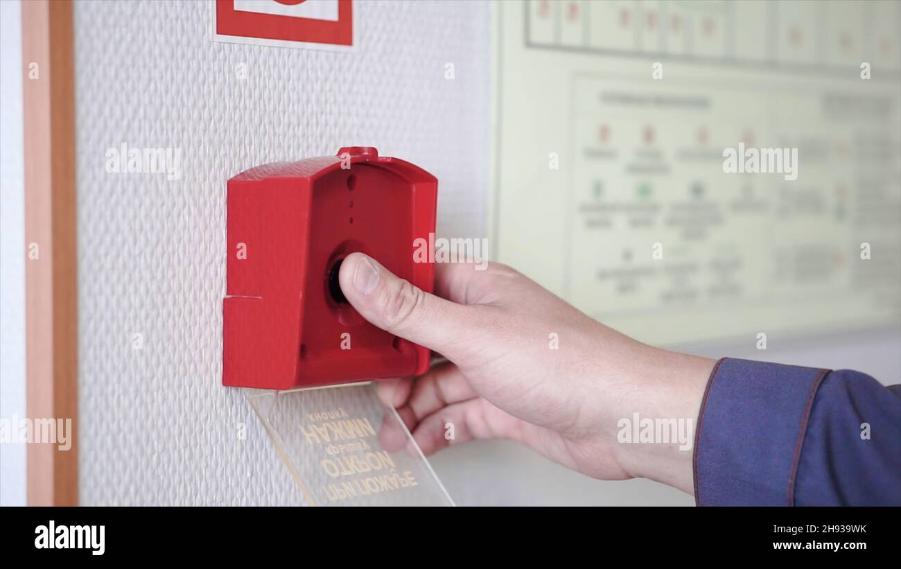 The hand of man is pushing fire alarm on the wall. Clip. Hand of man ...