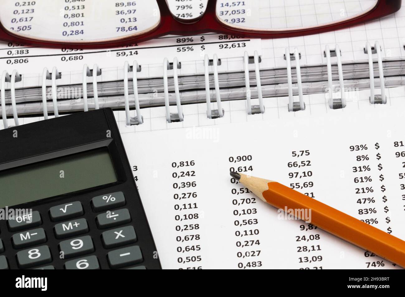 Financial report, calculator, pencil and glasses on the table in the ...