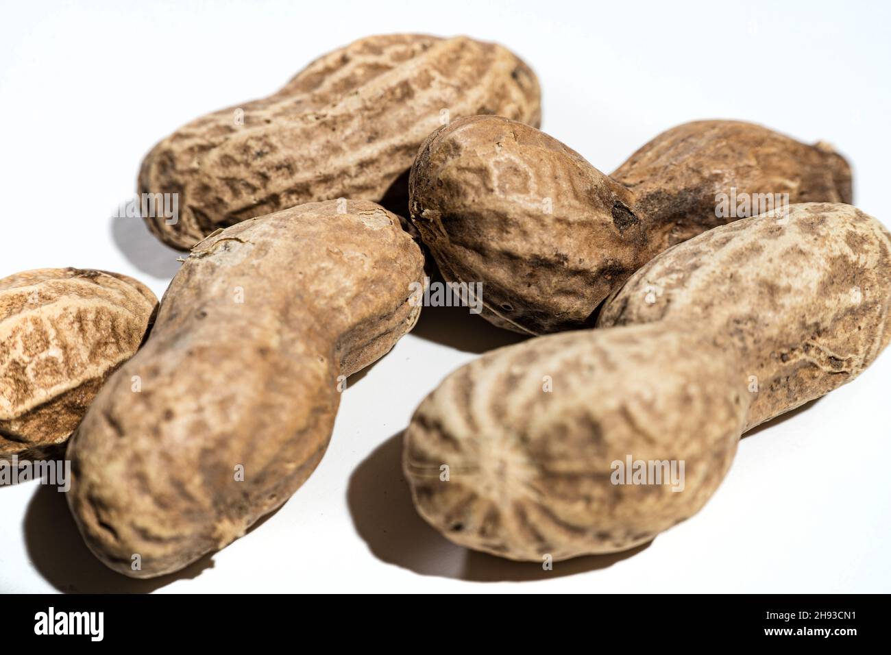 Various peanuts with shell on white background Stock Photo - Alamy
