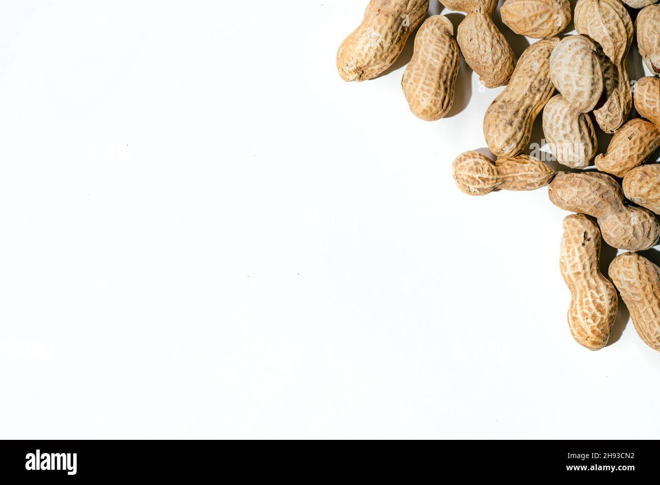 Various peanuts with shell on white background Stock Photo - Alamy