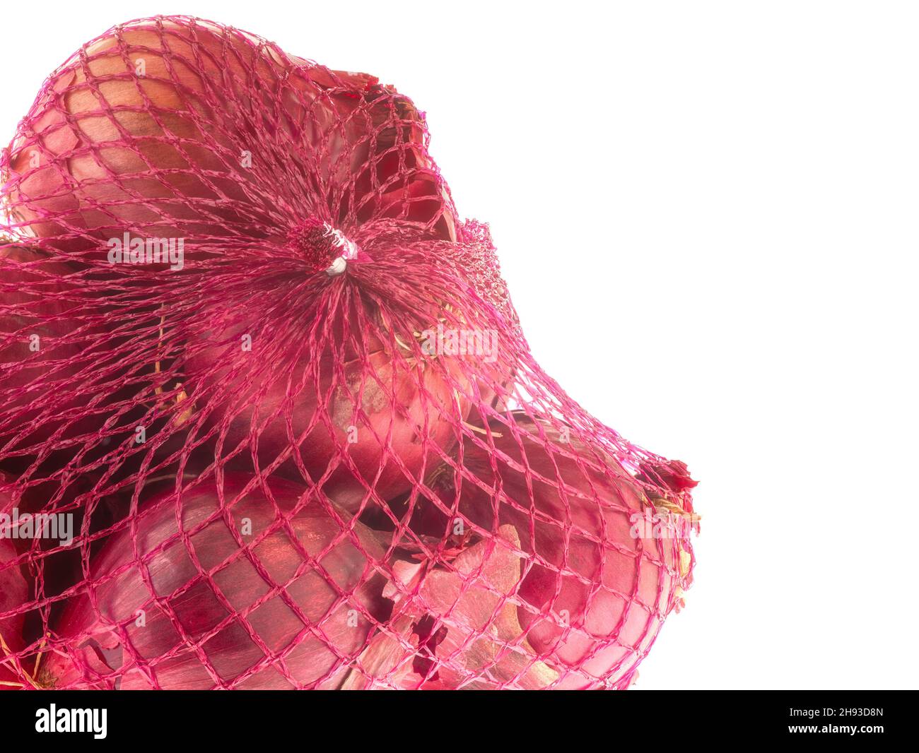 Food close-up still-life of Red Onions in their retail net bag against ...