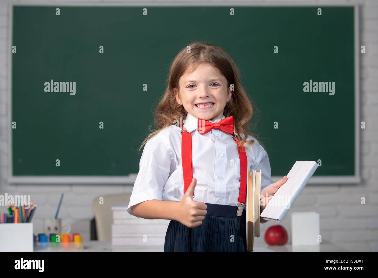 Portrait of cute, lovely, girl in school uniform in classroom Stock ...