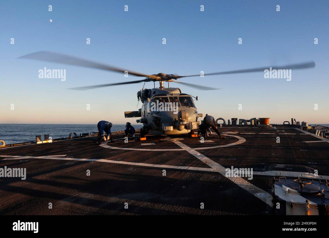 PACIFIC OCEAN (Nov. 14, 2021) Sailors chock and chain an MH-60R Seahawk ...