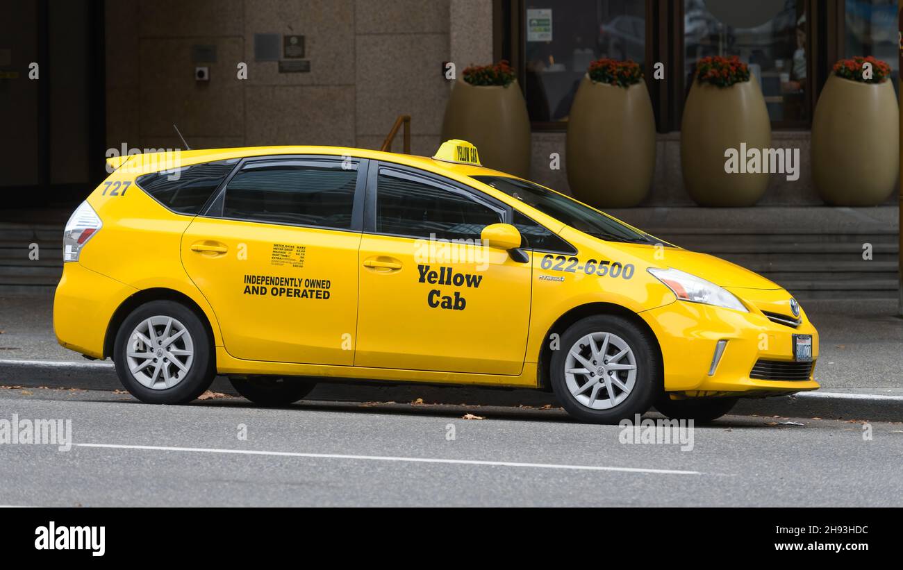 Seattle - November 21, 2021; A Yellow Cab taxi parked alongside a ...