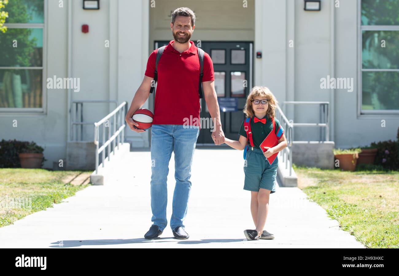 Father walking son to school. Parent and pupil of primary school ...