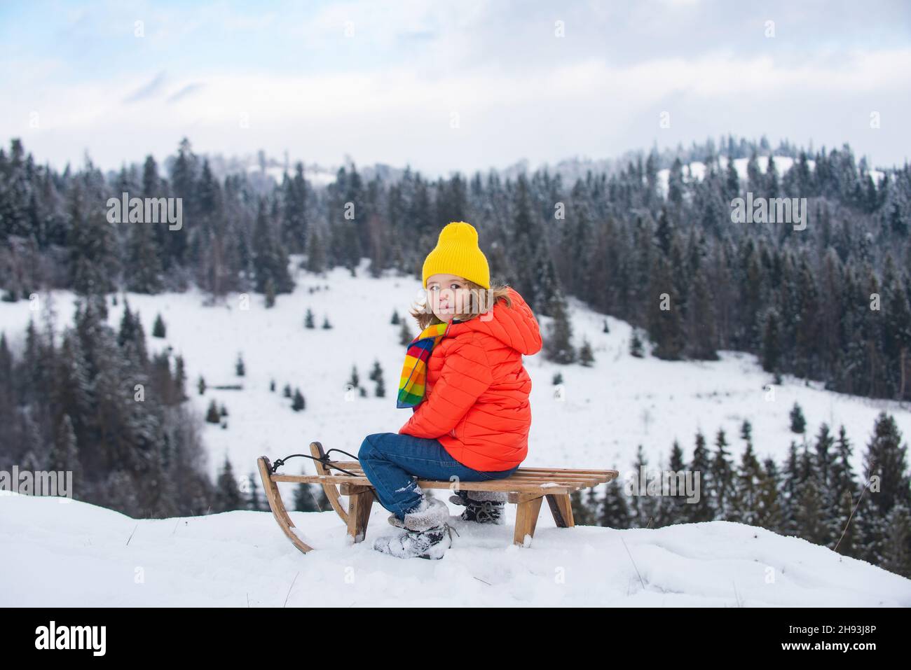 Portrait of happy little kid wearing knitted hat, scarf and sweater ...