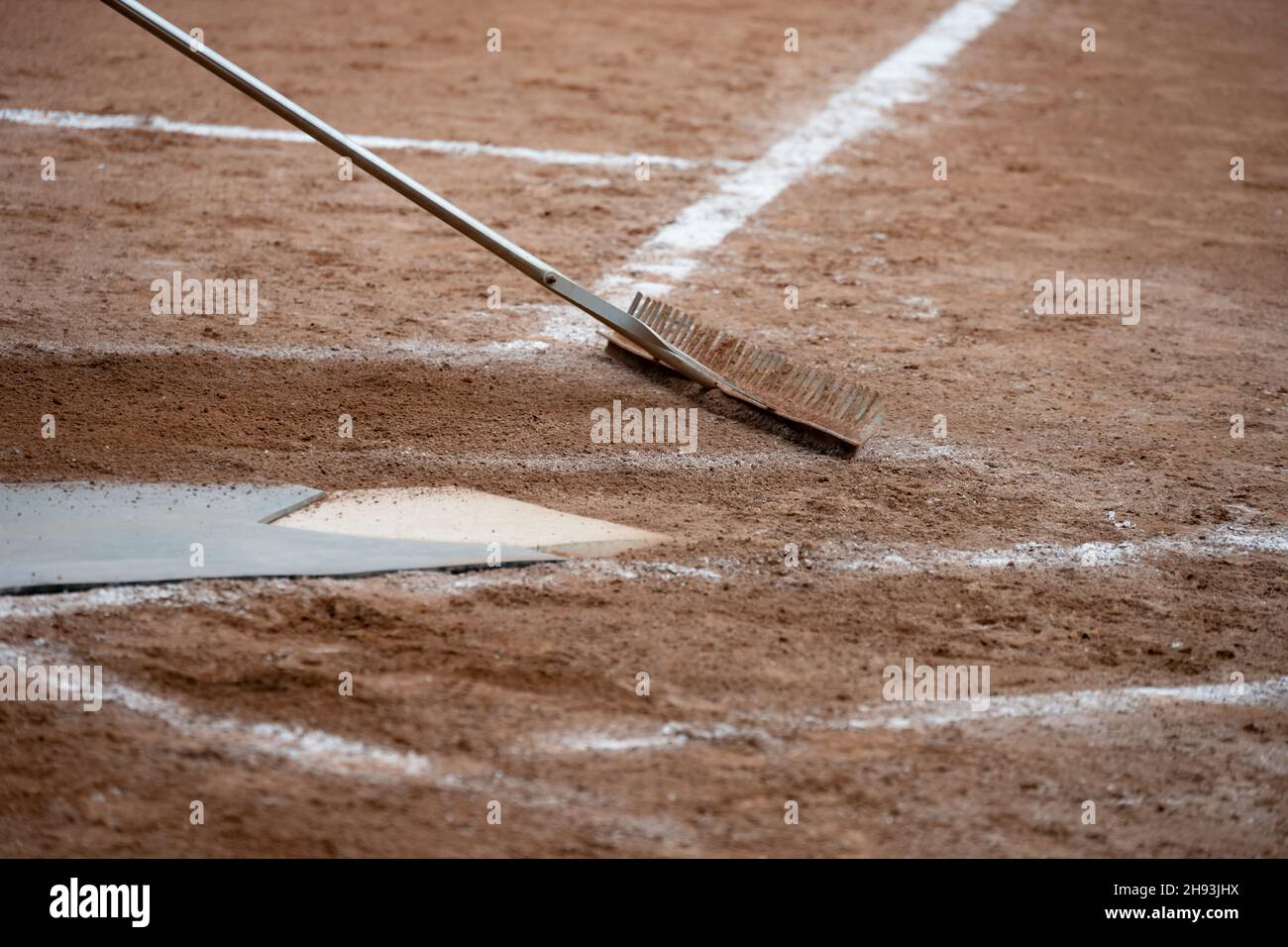 tidying up the base of a baseball field Stock Photo - Alamy