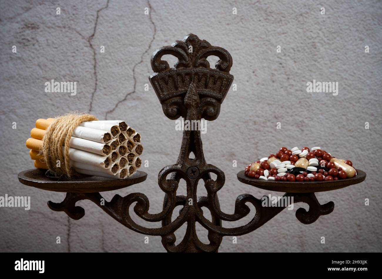 cigarettes and medicine on a balanced scale concept of unhealthy ...