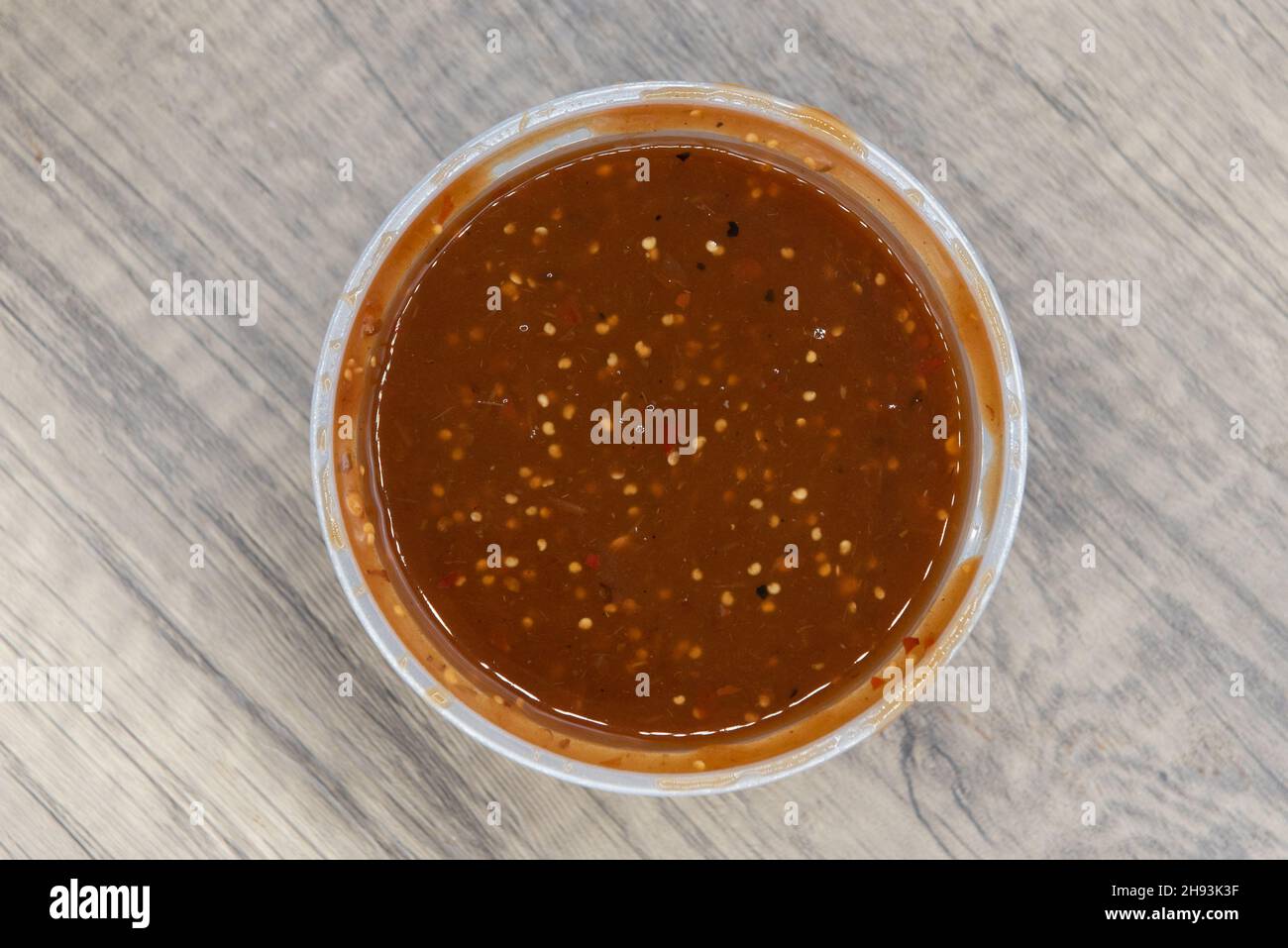 Overhead view of large container of fresh homemade red salsa ready to ...
