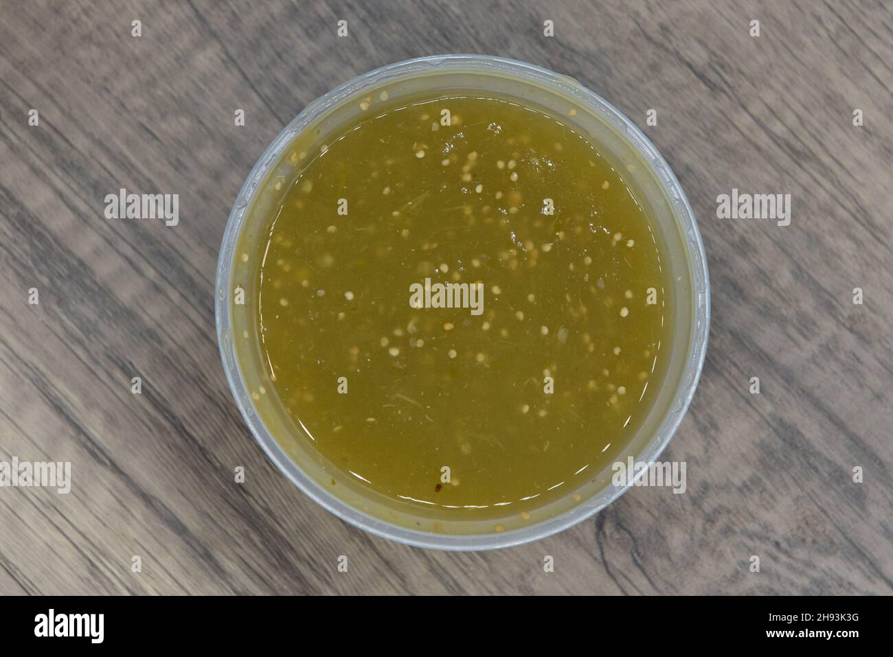 Overhead view of large container of fresh homemade red salsa ready to ...