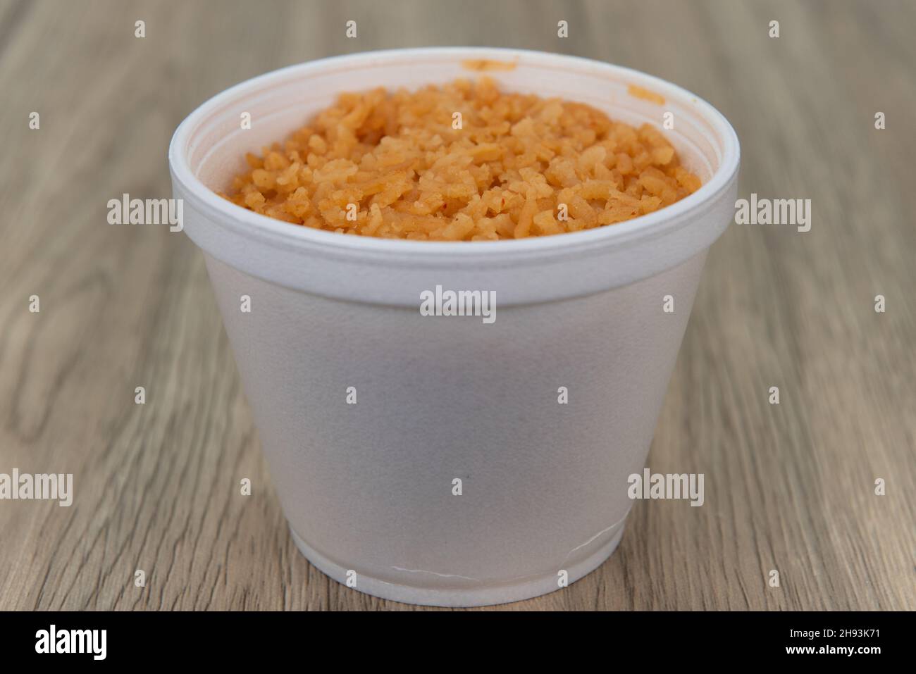 Generous portion of Mexcian rice in a small container to eat as a side ...