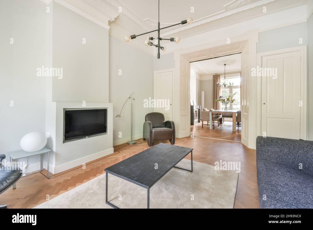 Cozy living room with large sofa and TV Stock Photo - Alamy