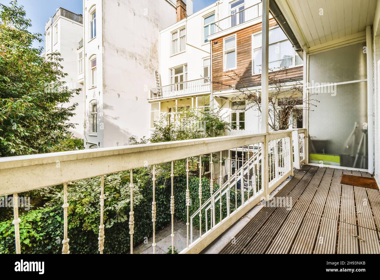 Attractive long narrow balcony with wooden handrails Stock Photo - Alamy