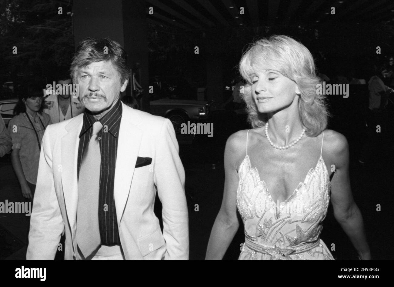 Charles Bronson and Jill Ireland at the wedding reception for producer Al Ruddy and newspaper ...