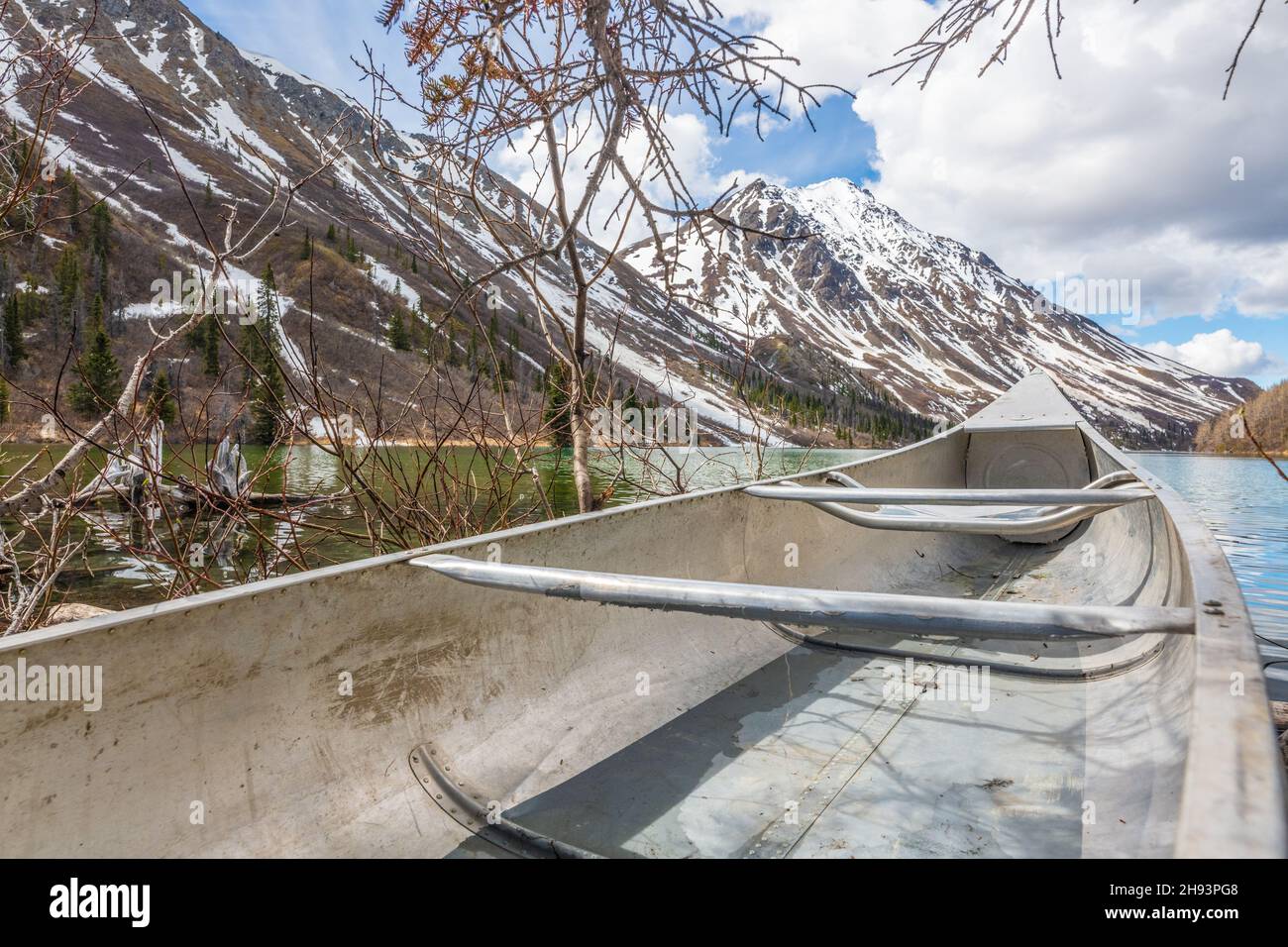 Steel frame canoe in outdoor setting with snow on mountains in distance ...