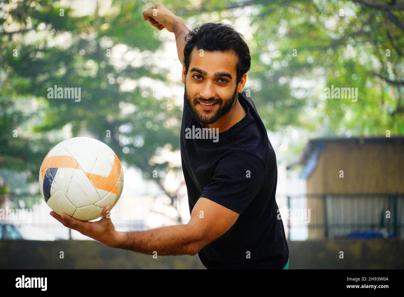Young football Player having ball image in hand Stock Photo - Alamy
