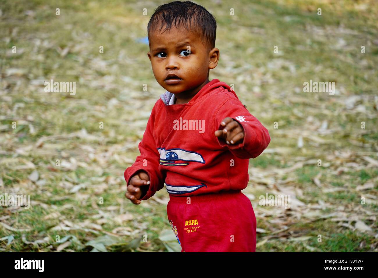 a poor indian kid is playing in park Stock Photo - Alamy