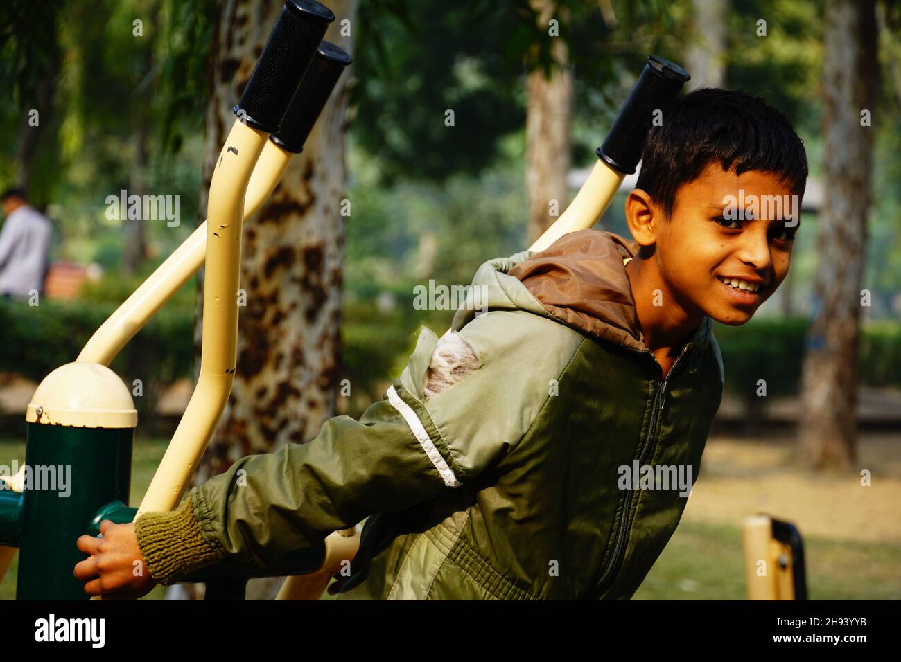 a poor indian kid is playing in park Stock Photo - Alamy