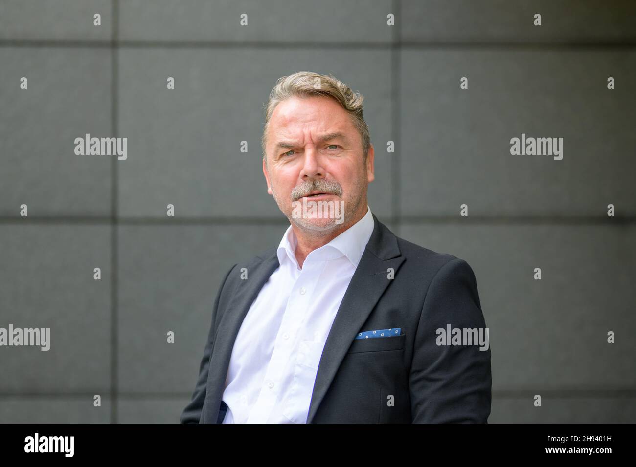 Side view portrait of a serious handsome middle-aged man making a funny ...