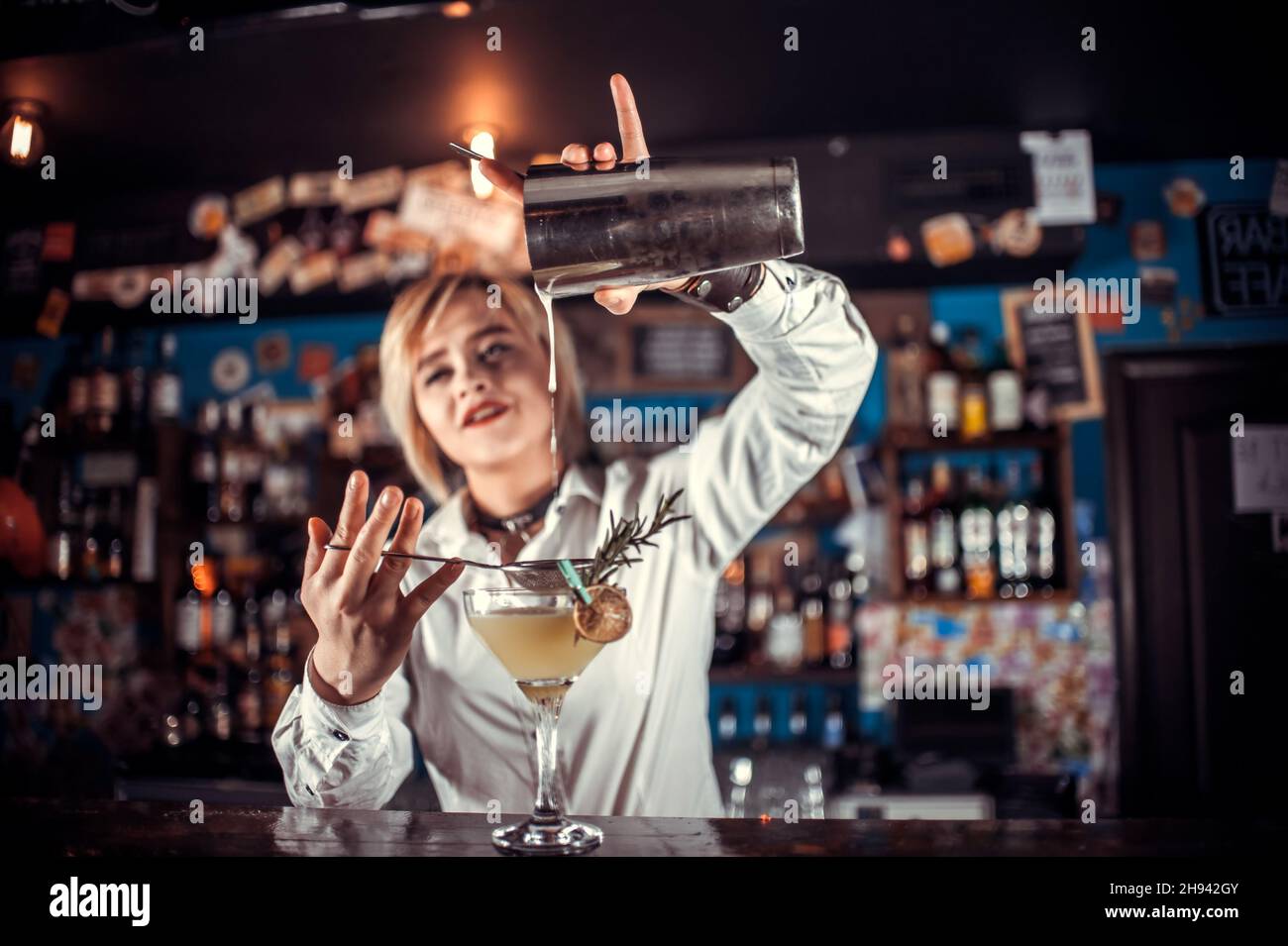 Sweet woman bartending formulates a cocktail Stock Photo - Alamy