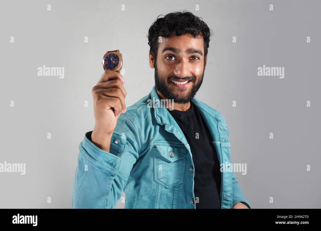 a man showing his watch in white background Stock Photo - Alamy
