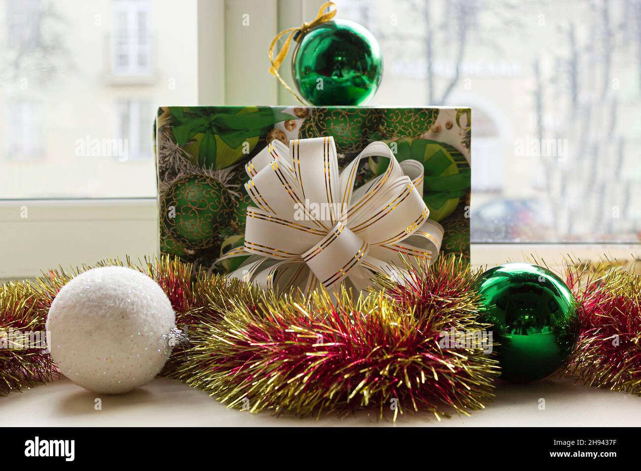 Christmas decorations on the window. Gift wrapping with Christmas balls ...