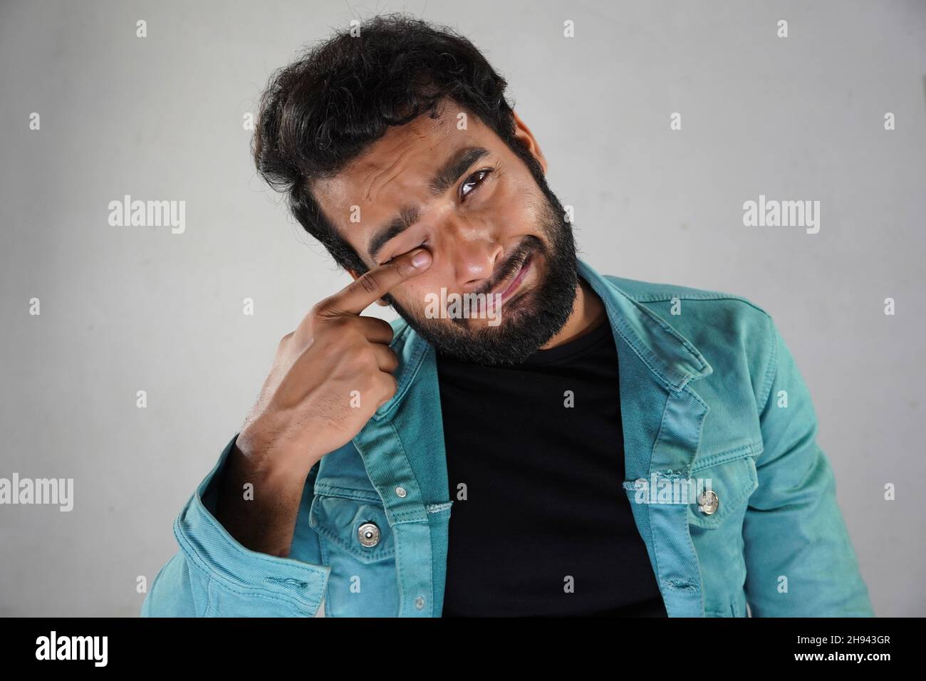 a man doing overacting in white background Stock Photo - Alamy