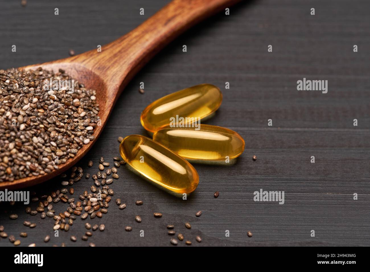 Organic natural chia seeds and wooden scoop close-up on wooden ...