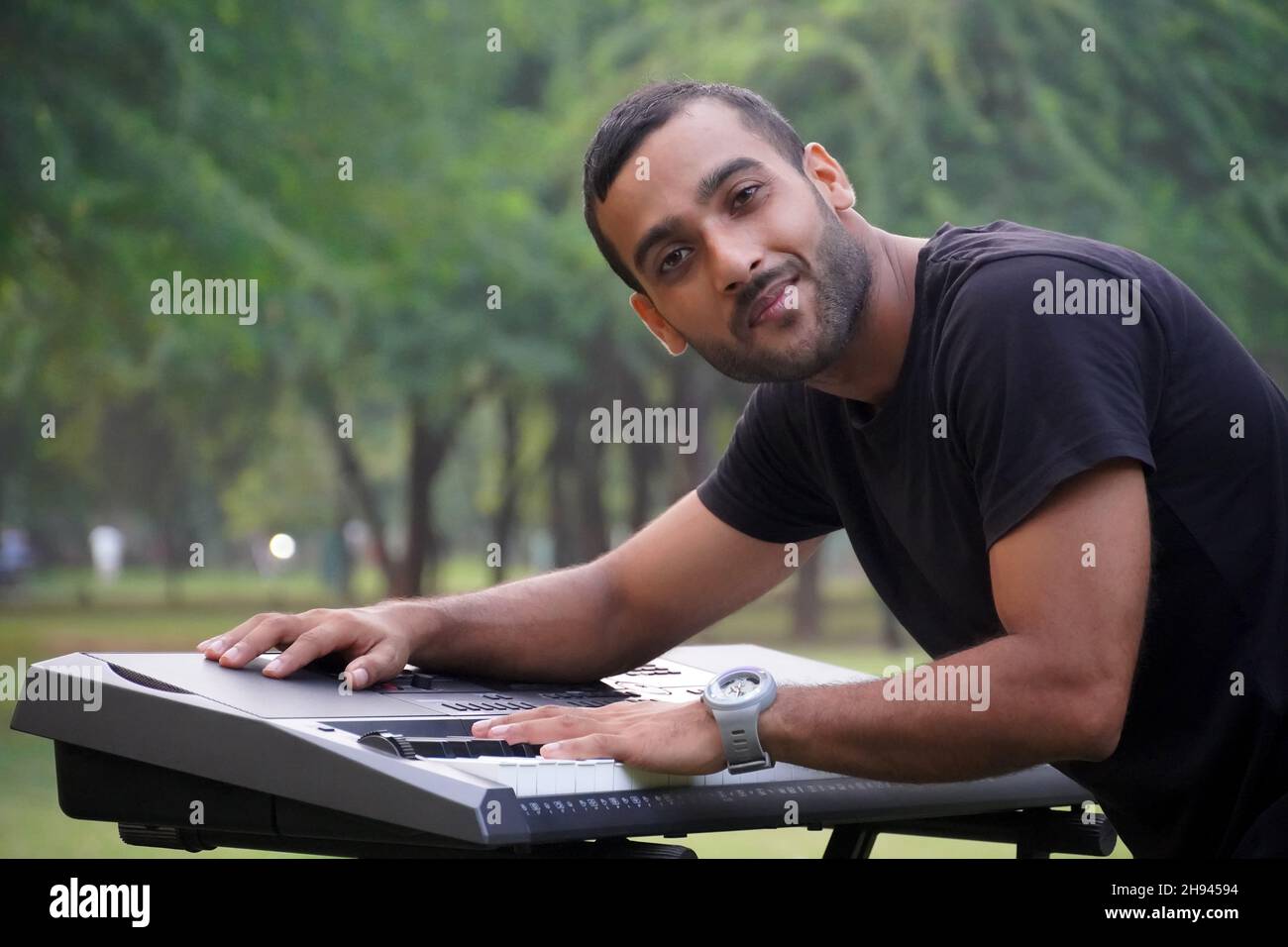 Young passionate man playing electric piano stock photo Stock Photo - Alamy