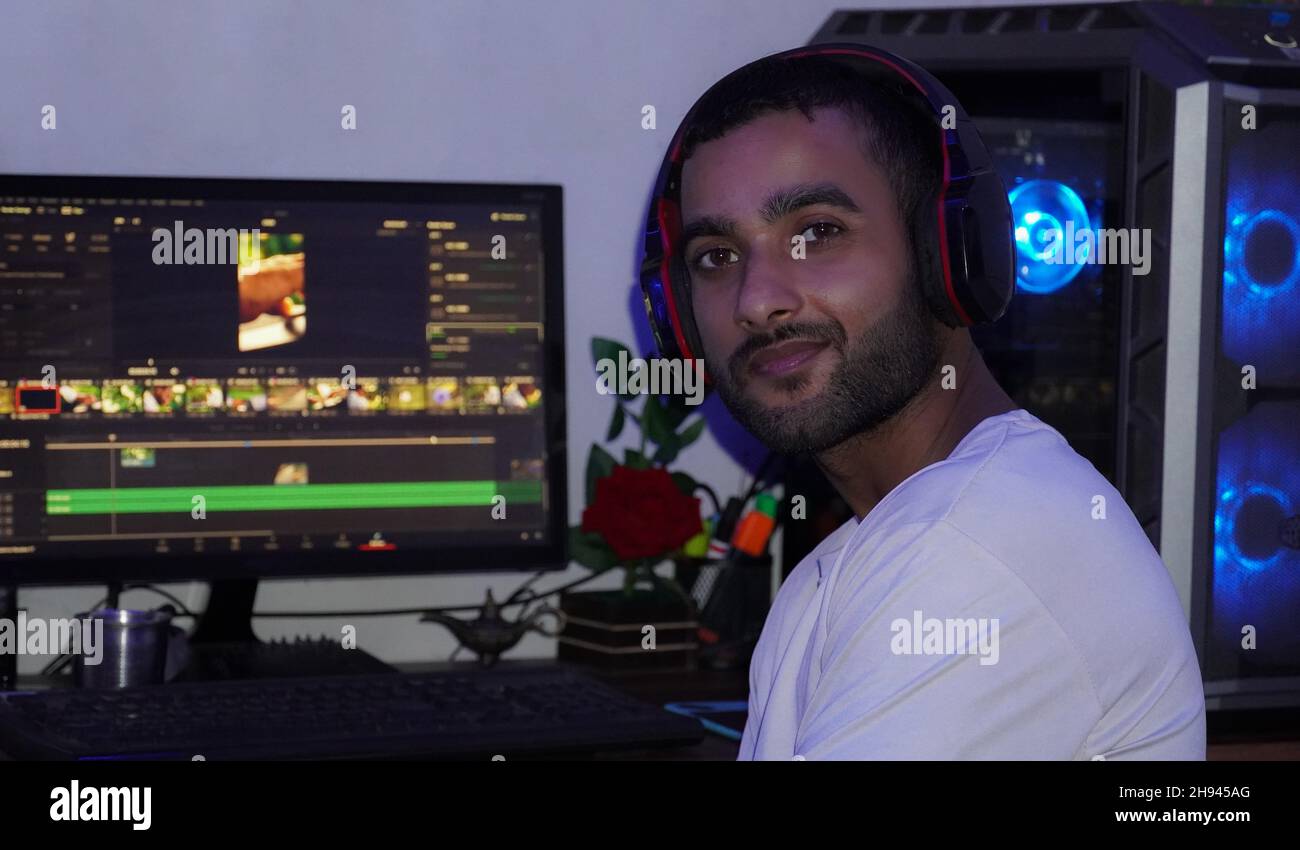 Young man is concentrating while working at his desk hi-res stock ...