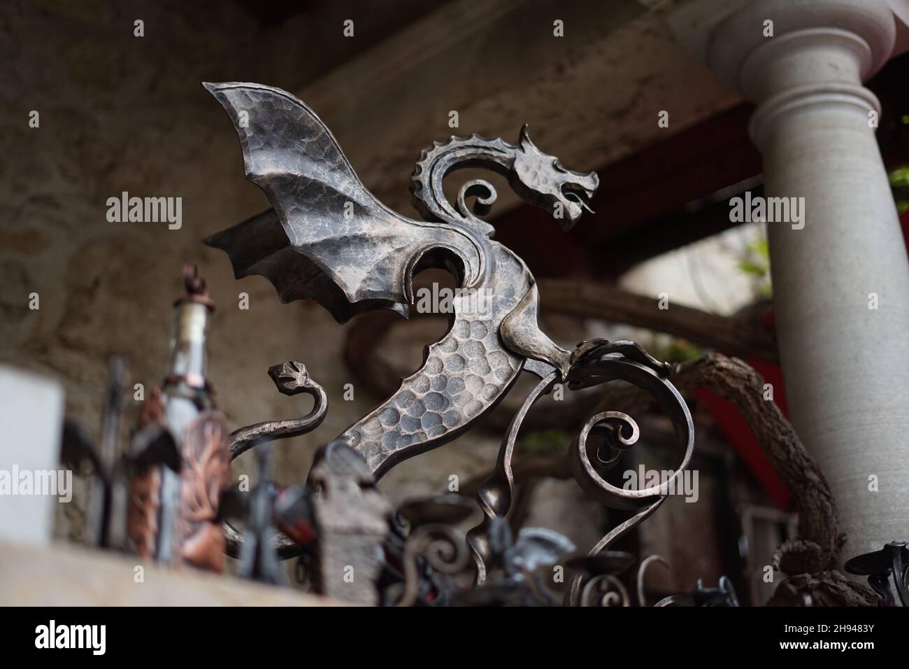 Decorative metal dragon as an ornament of a fence Stock Photo - Alamy
