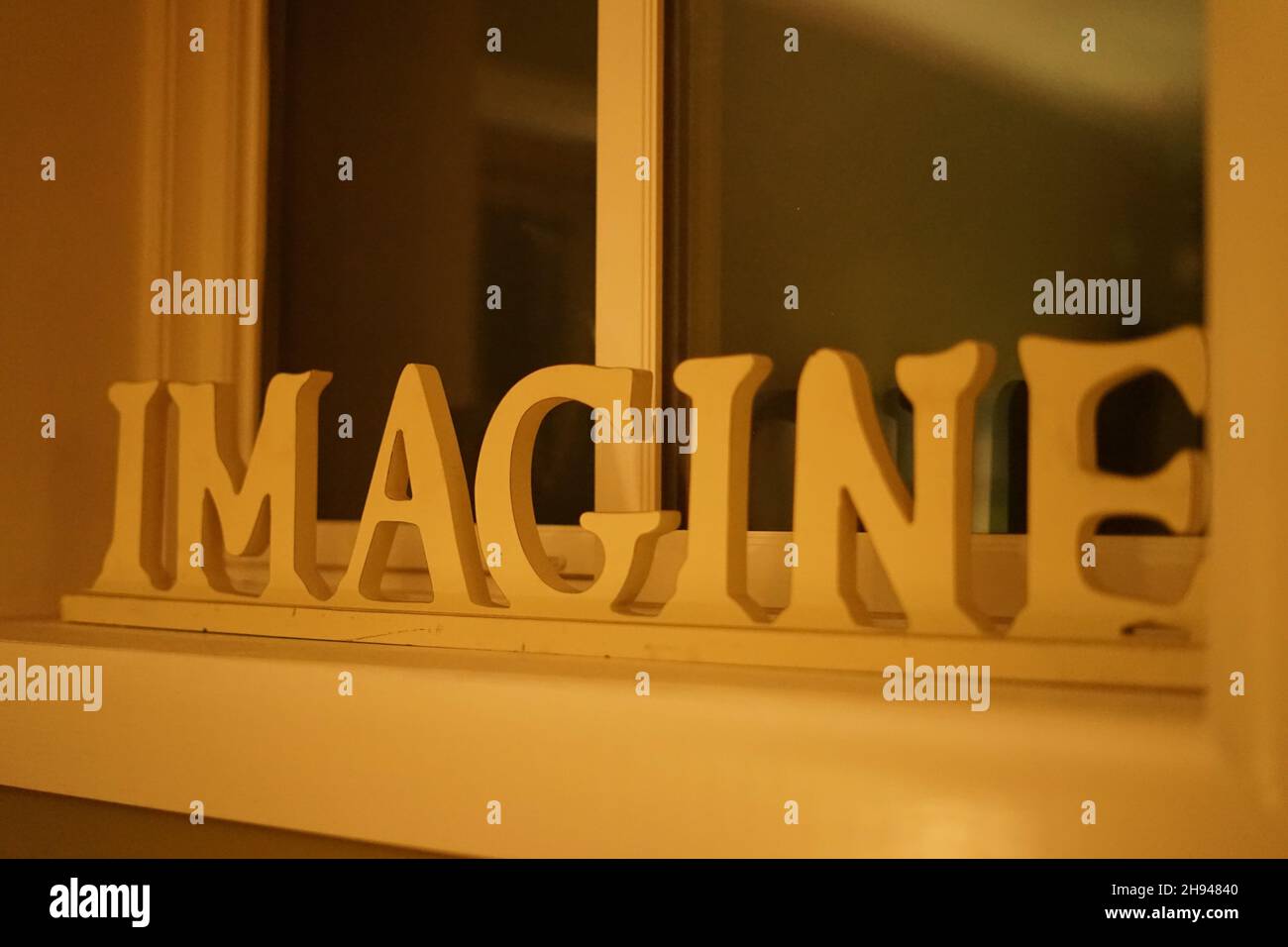 Wooden decoration with 'imagine' word on a windowsill Stock Photo - Alamy