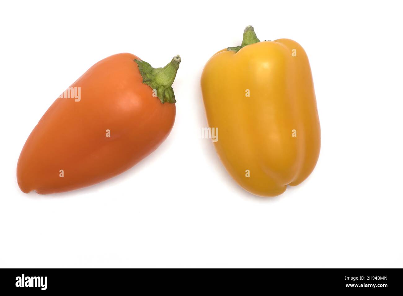 two colored snack bell pepper pod in orange and yellow isolated on ...