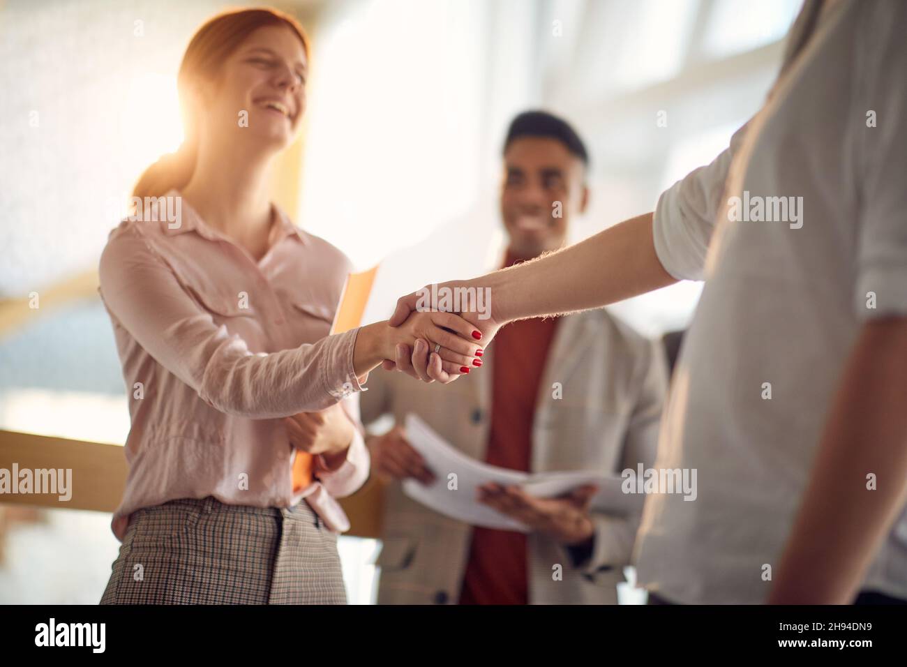 A young businesswoman is glad she met her colleagues in a friendly ...