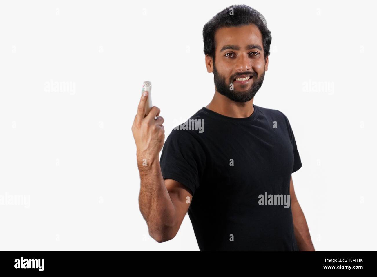 A Young man with Remote in white background Stock Photo - Alamy