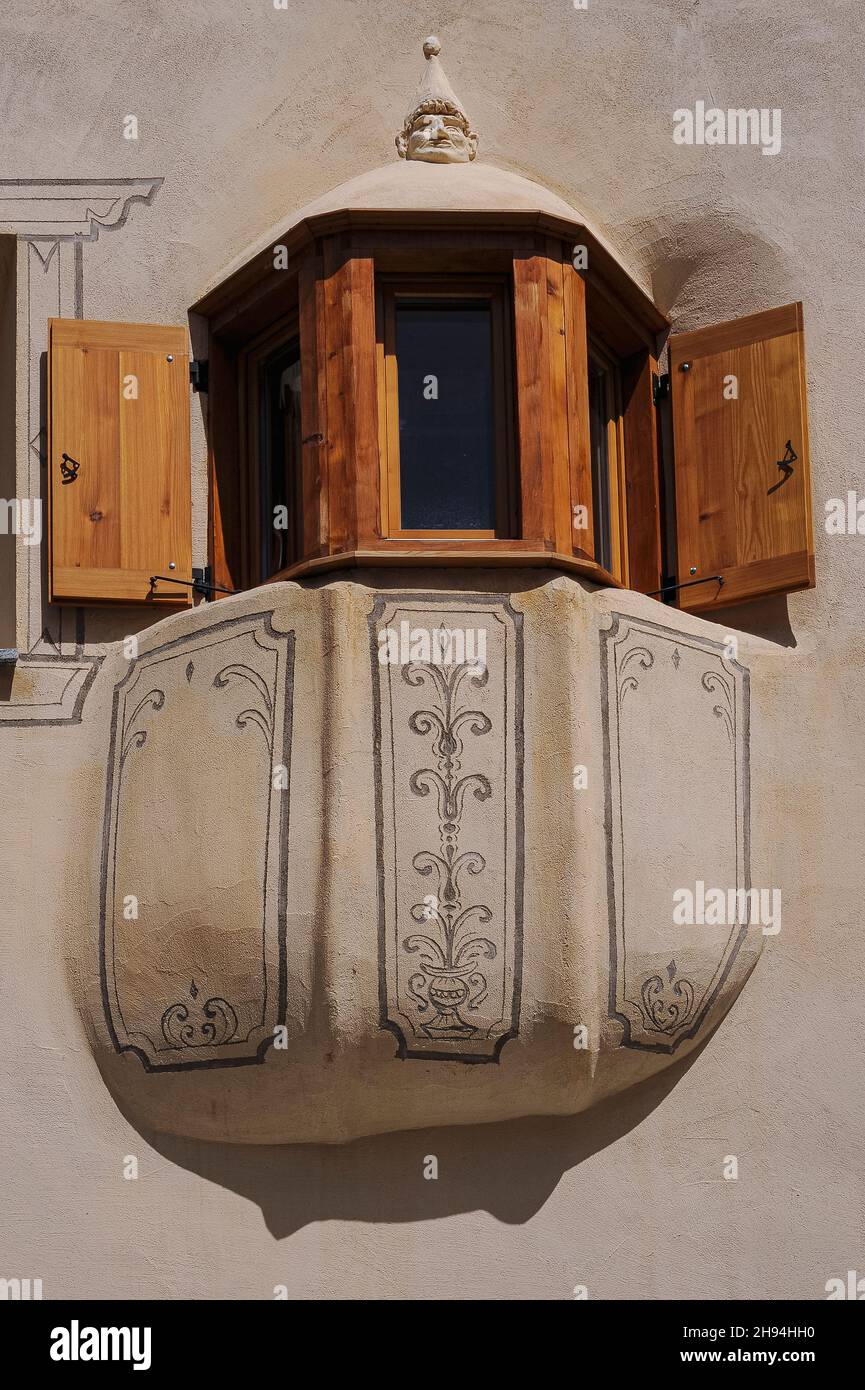 Swiss gnome in pointed hat watches the world go by from on top of a ...