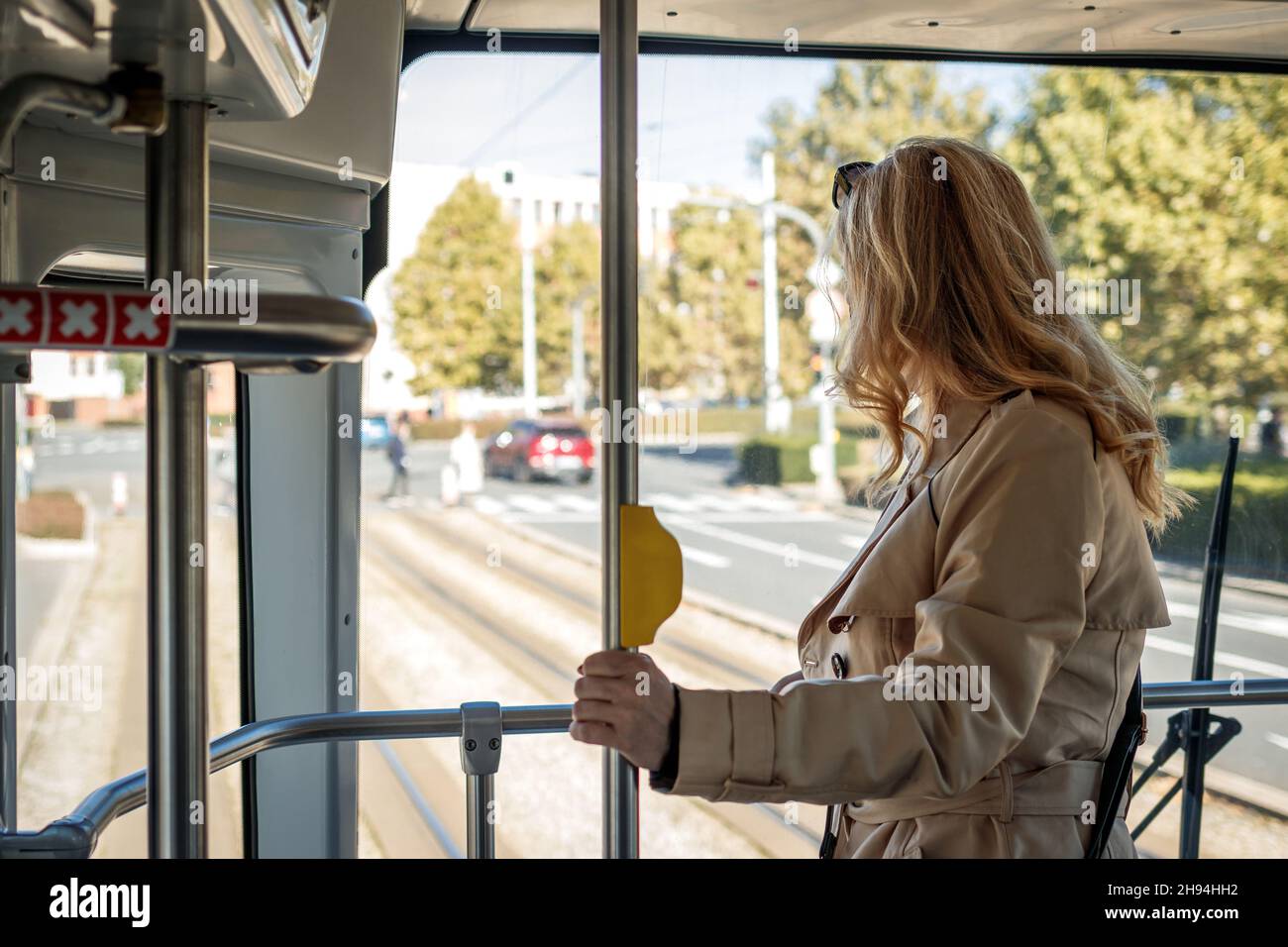 Woman commuting to work by tramway. Public transportation in city ...