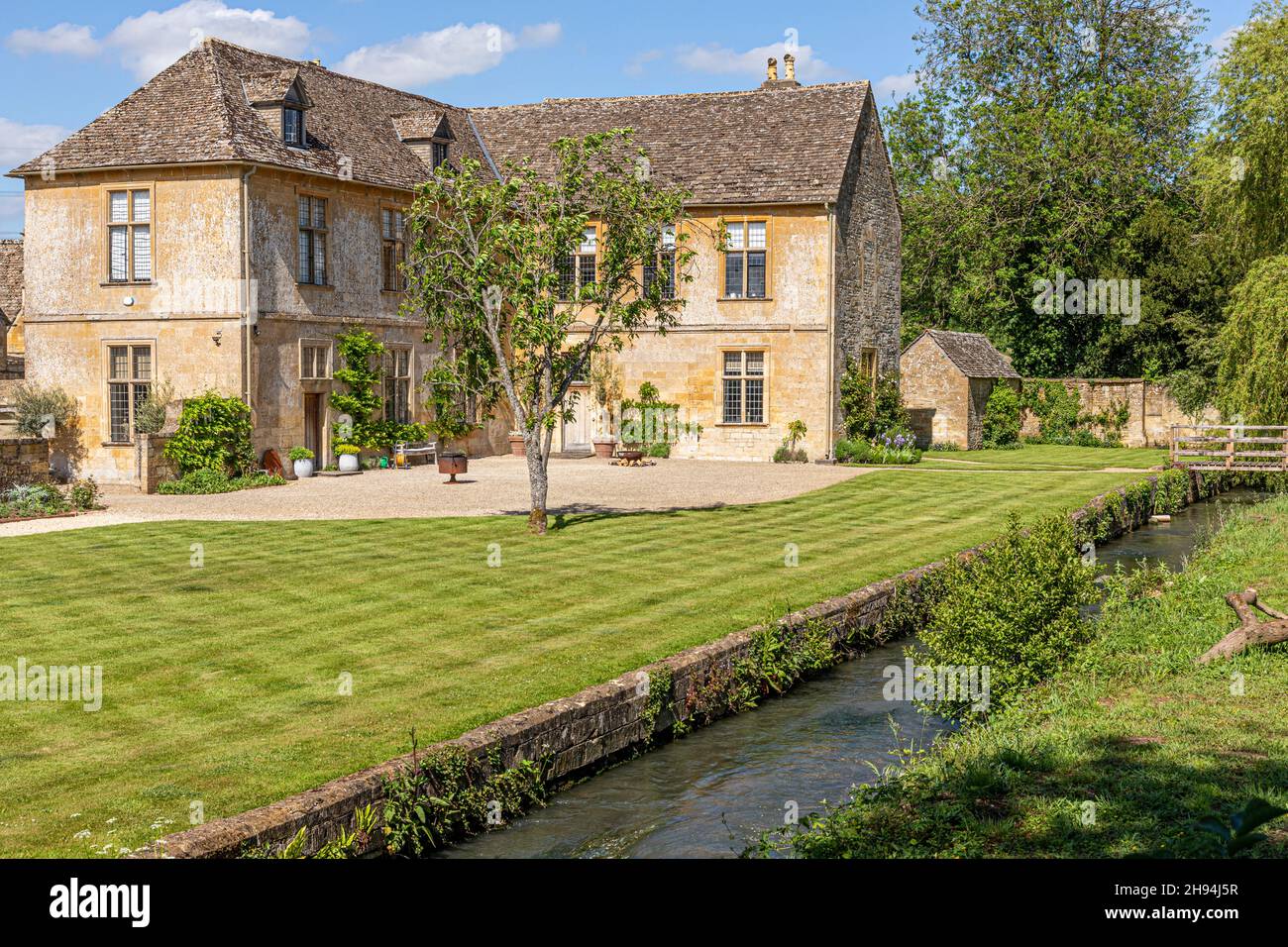 17th century Cassey Compton House in the valley of the infant River ...