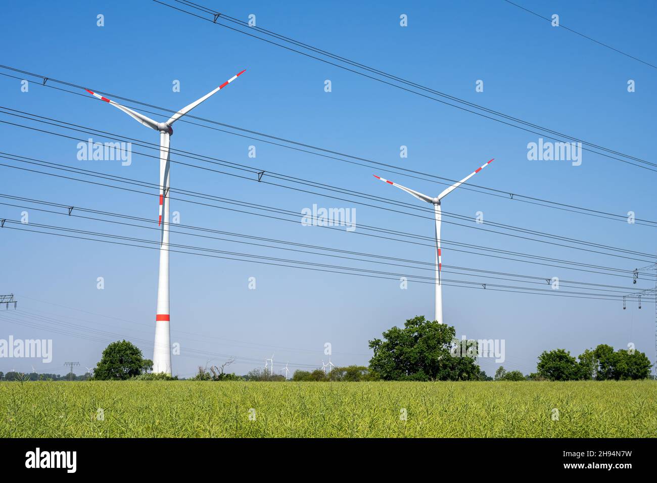 Overhead power lines and wind turbines seen in rural Germany Stock ...