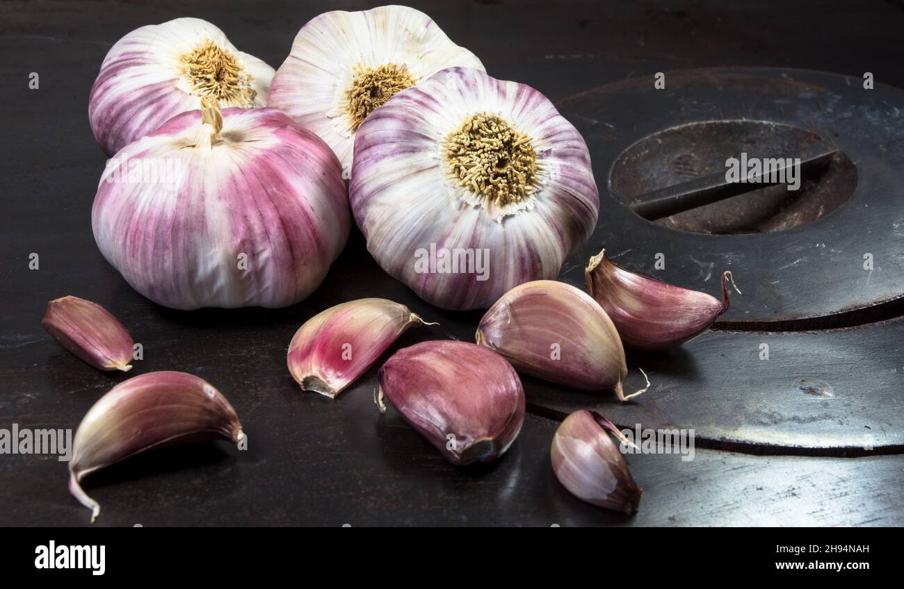 Heap of garlic on the iron plate of a wood stove Stock Photo - Alamy