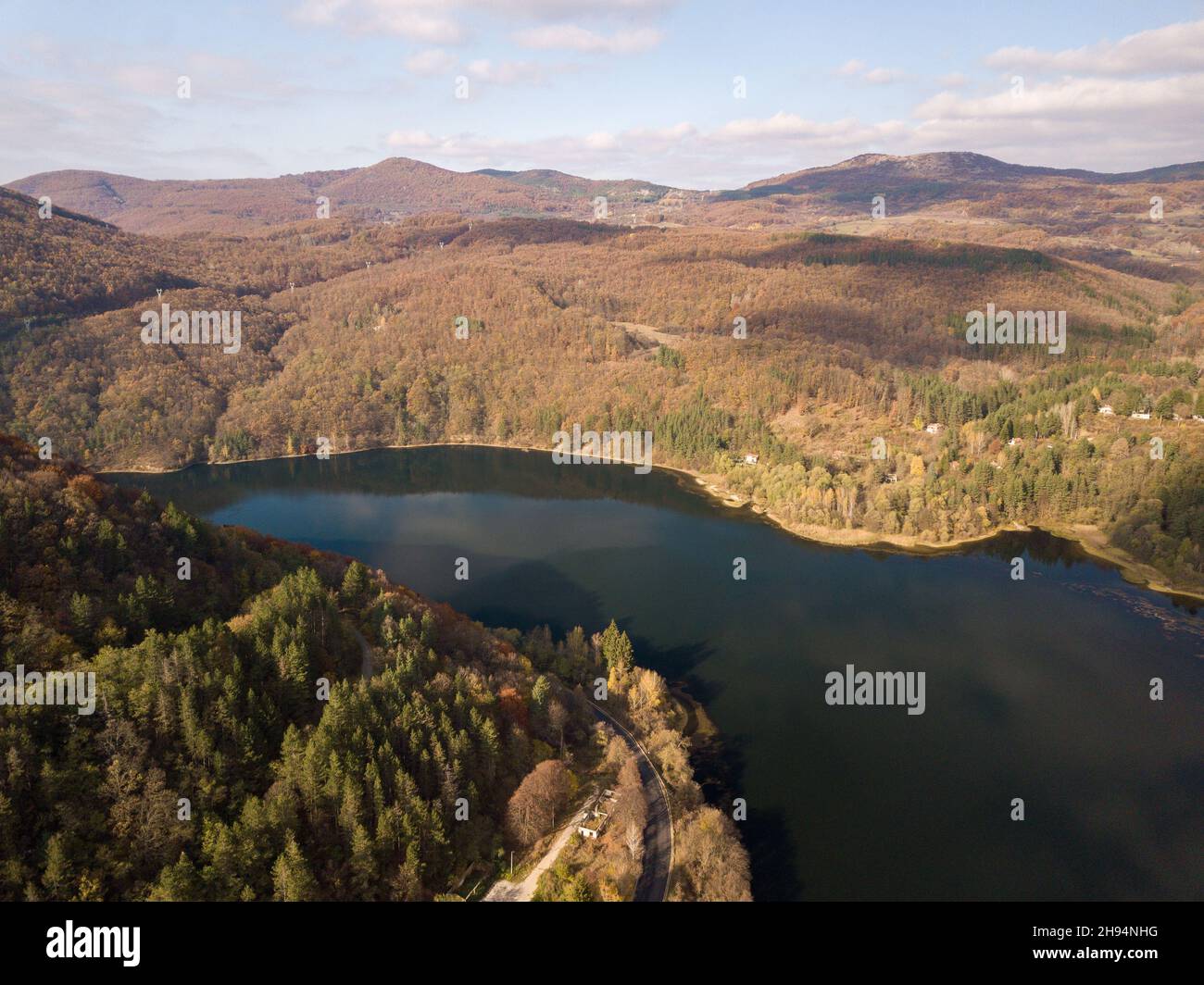 Aerial shot of a small lake in the middle of cliffs and autumn view of ...