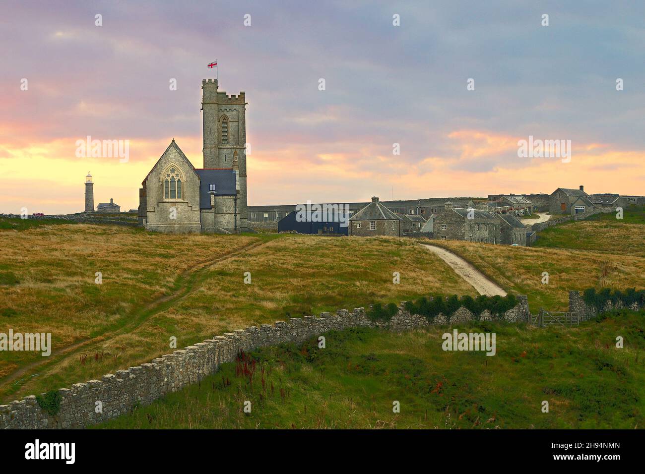 Sunset over St Helen's Church, Old Light and Lundy village on Lundy ...