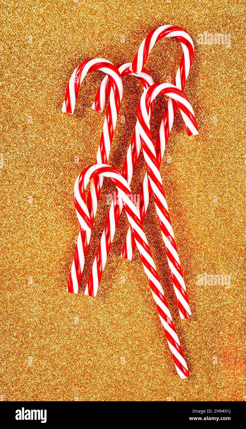 Candy canes on gold background. Christmas decoration Stock Photo - Alamy