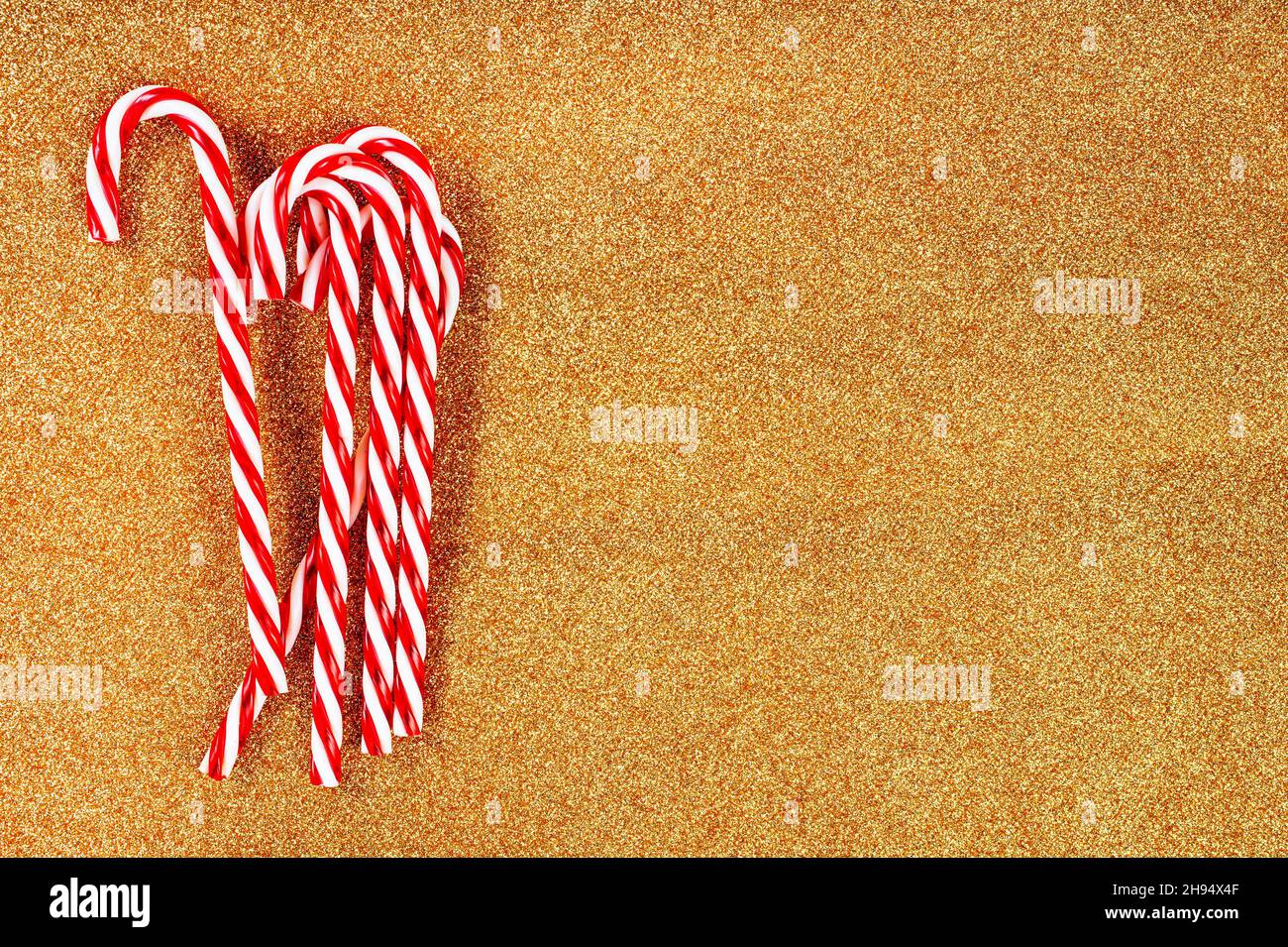 Candy canes on gold background. Christmas decoration Stock Photo - Alamy