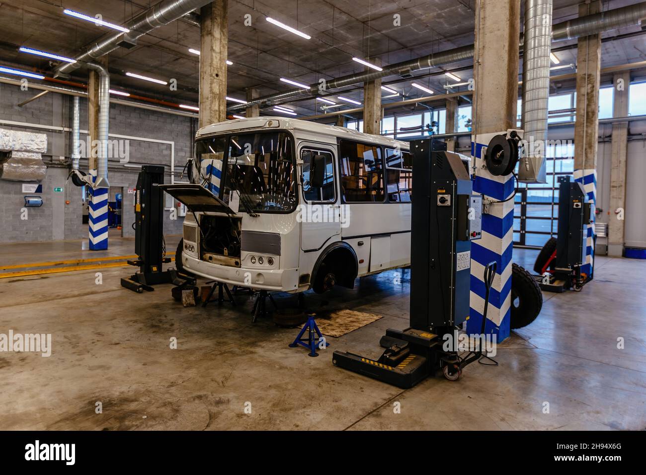 Buses in the modern repair service workshop Stock Photo - Alamy
