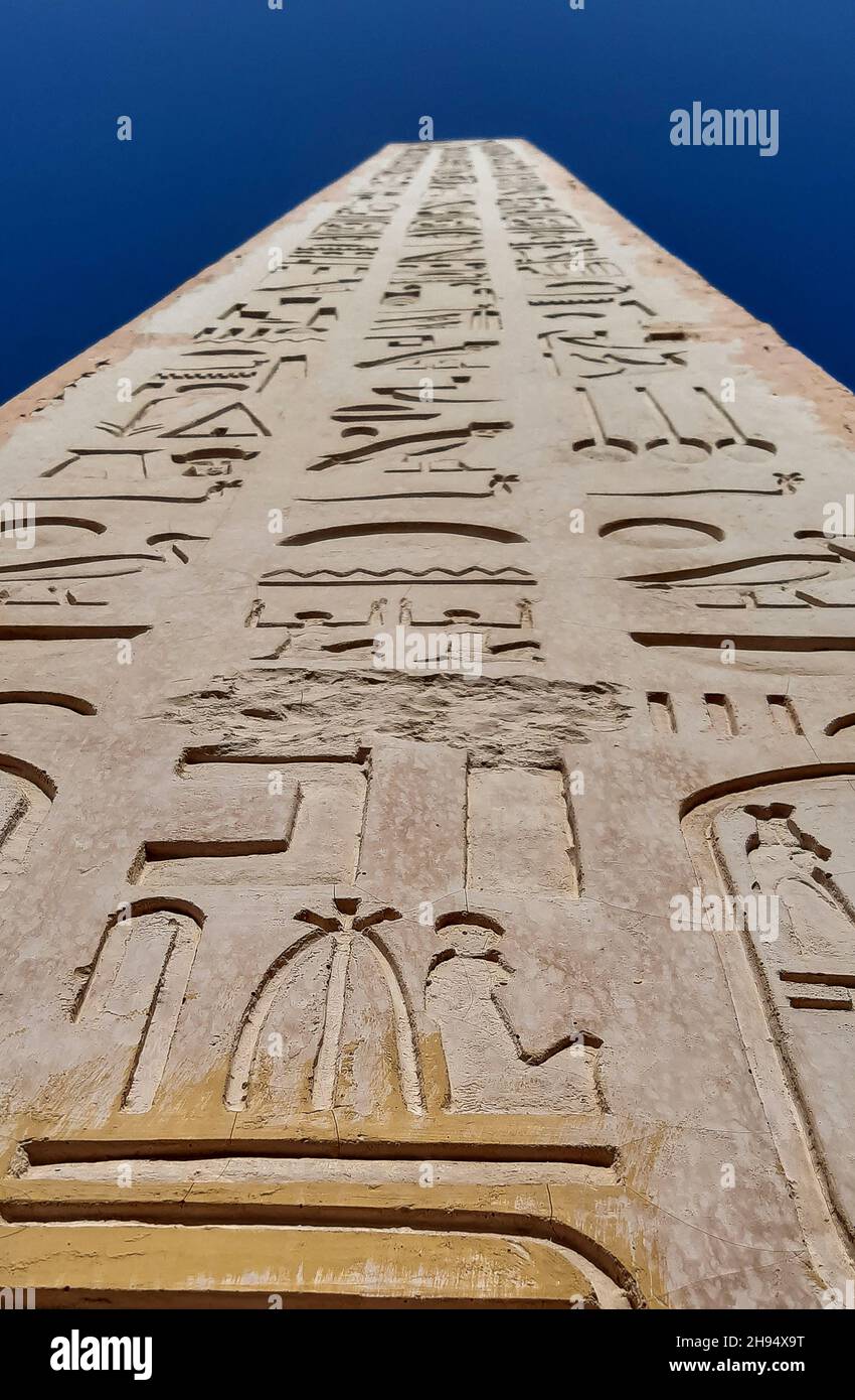 A tall obelisk with Egyptian hieroglyphs and inscriptions extending ...
