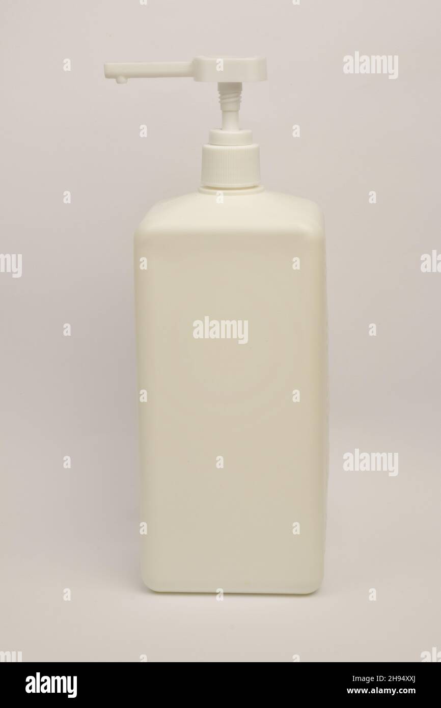 White plastic container for liquid with a dispenser on a white ...