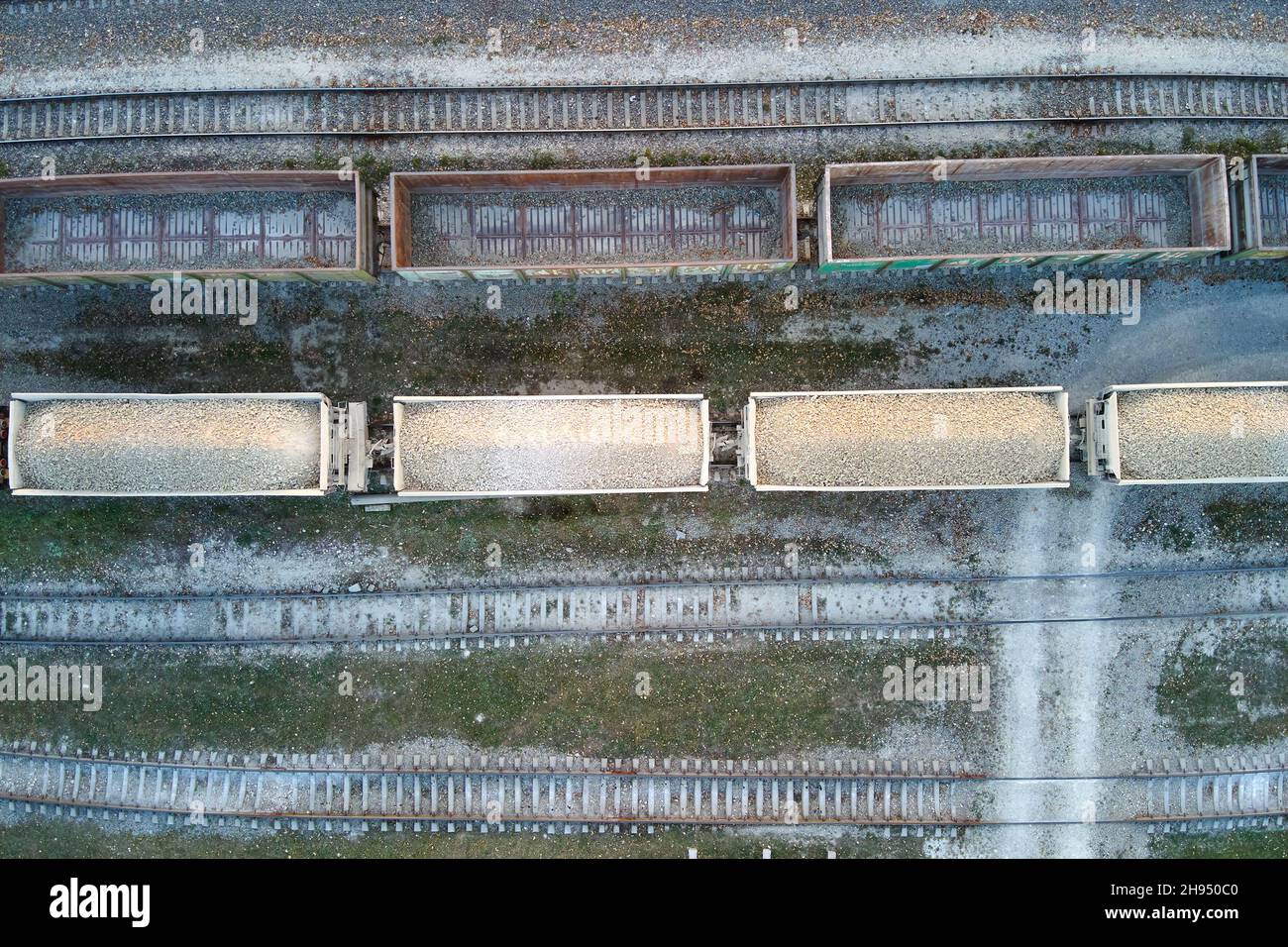 Aerial view of cargo train loaded with crushed stone materials at ...