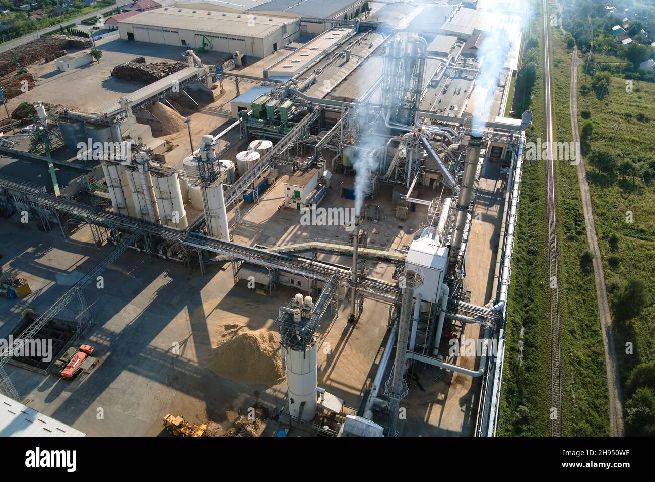Aerial view of wood processing factory with stacks of lumber at plant ...